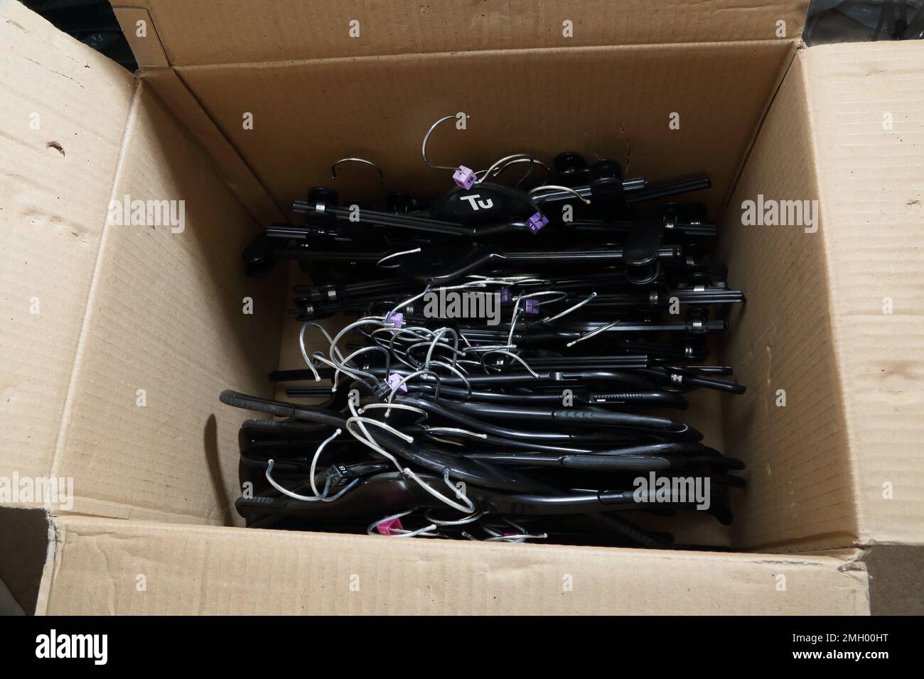 Cardboard Box full of Plastic Hangers Stock Photo - Alamy