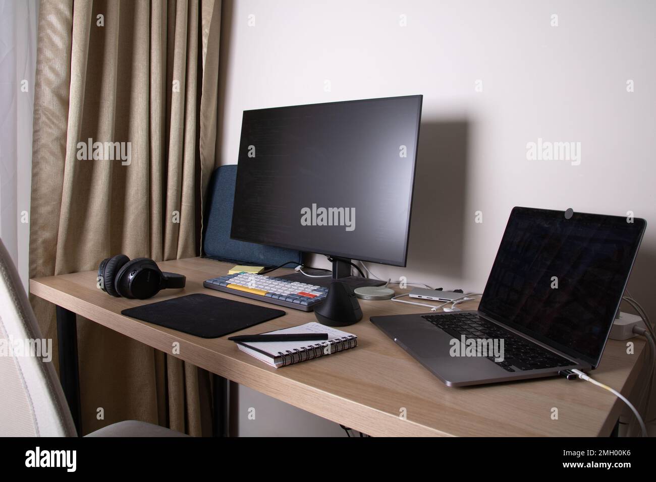 photo workstation: monitor, computer mouse, laptop stand on a wooden ...