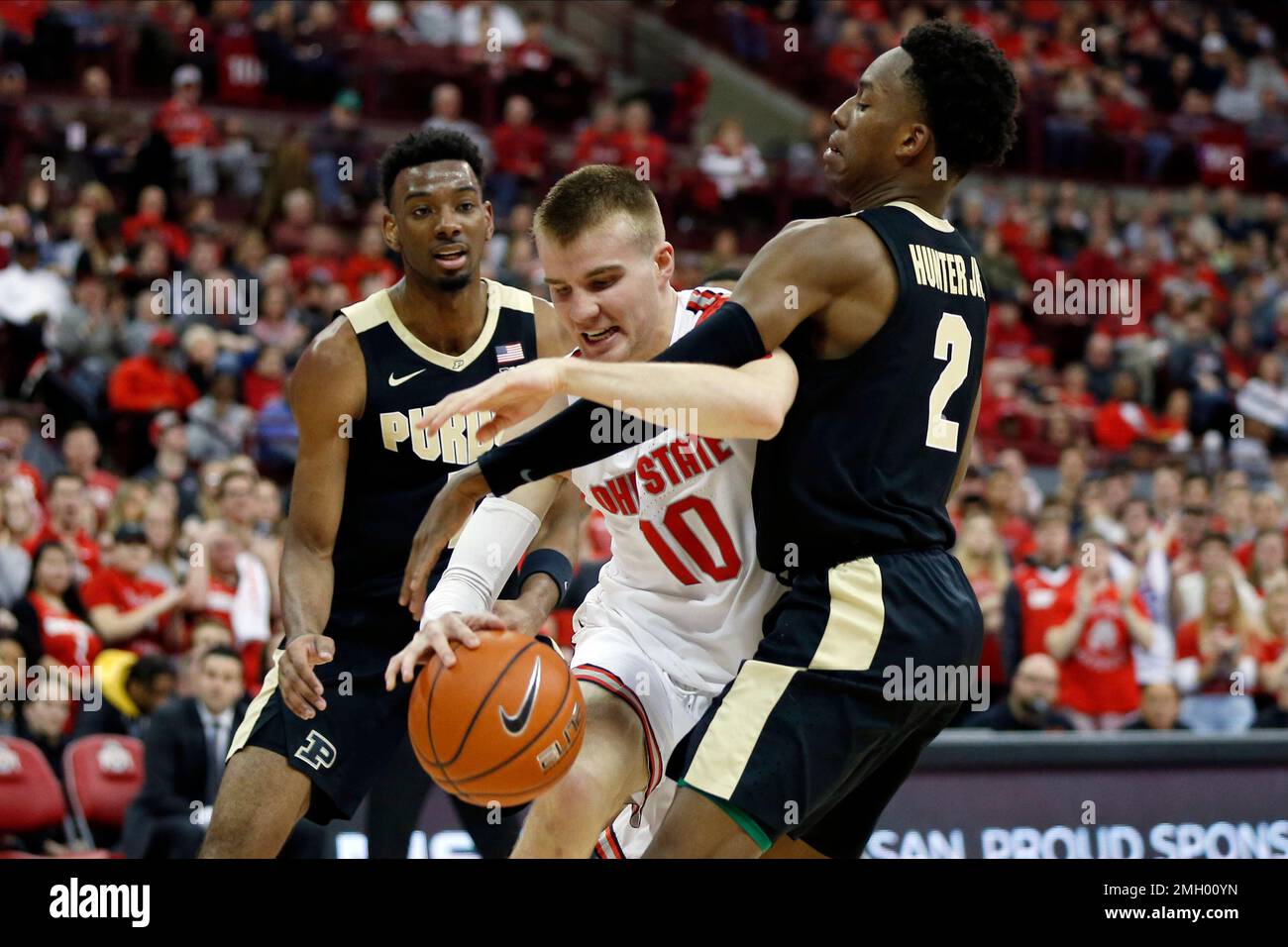 Ohio State's Justin Ahrens, center, tries to control a rebound against ...
