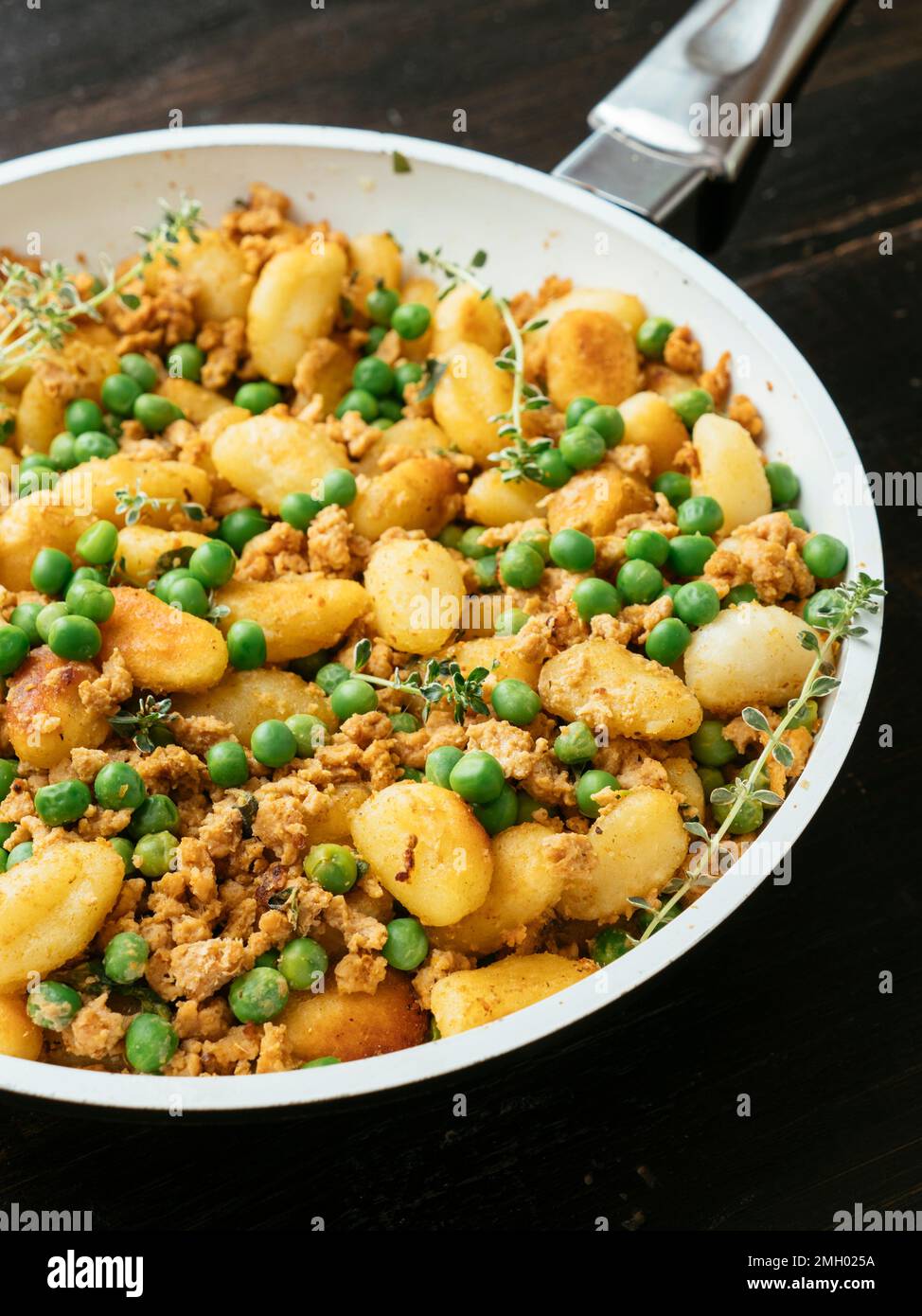 Frying pan with Gnocchi with Italian Spiced TVP and Peas Stock Photo ...