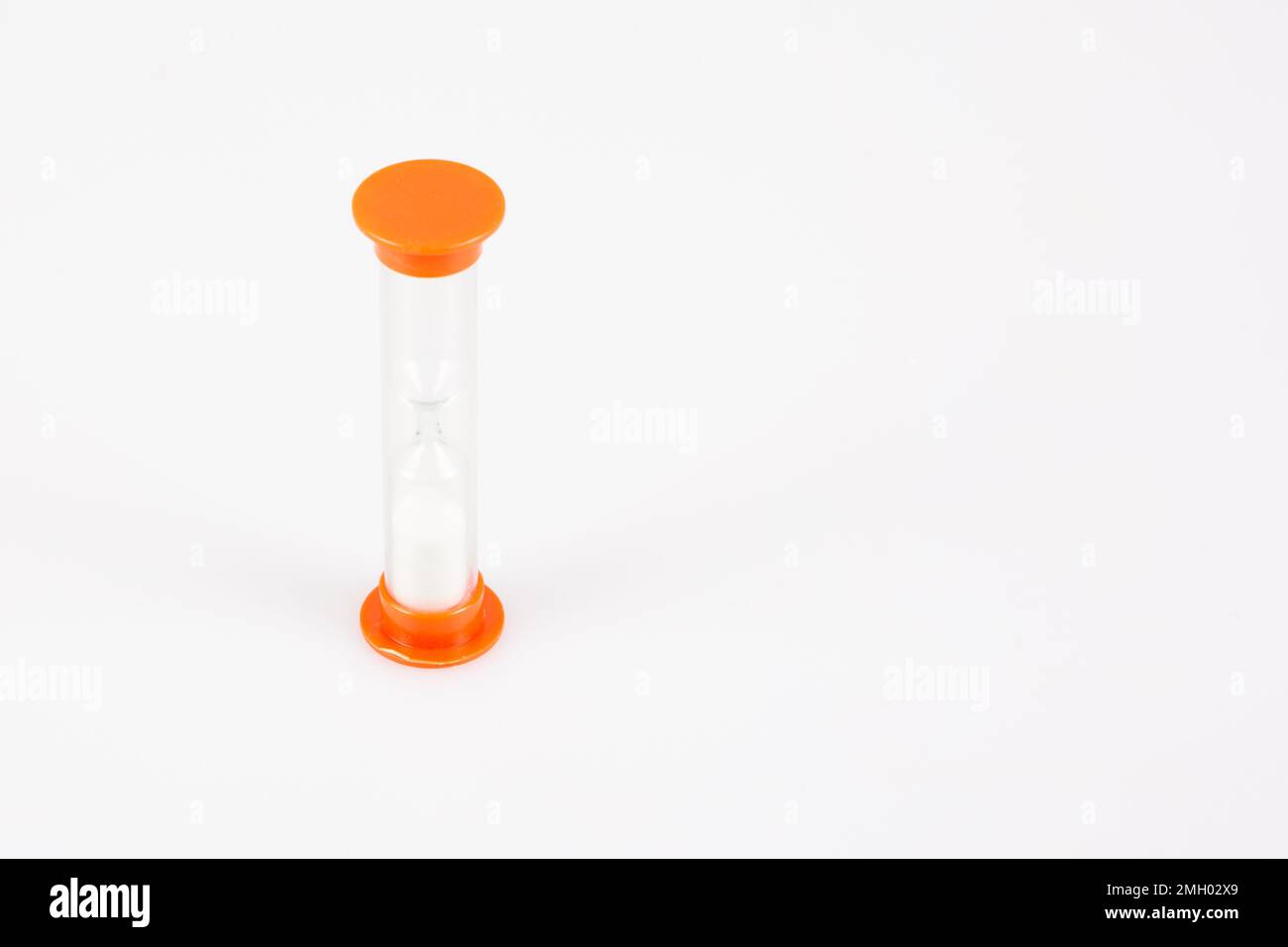 hourglass sandy timer in plastic orange in grey background with white ...