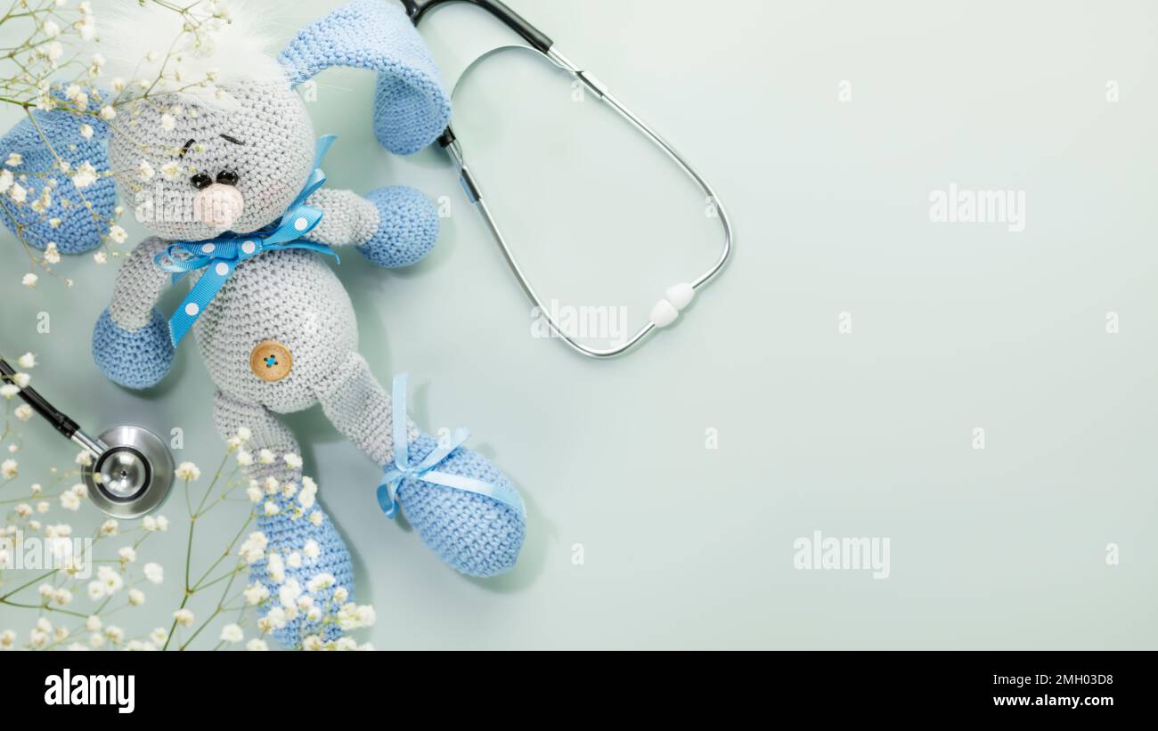 Kids health care still life. Cute knitted toy rabbit with a stethoscope ...