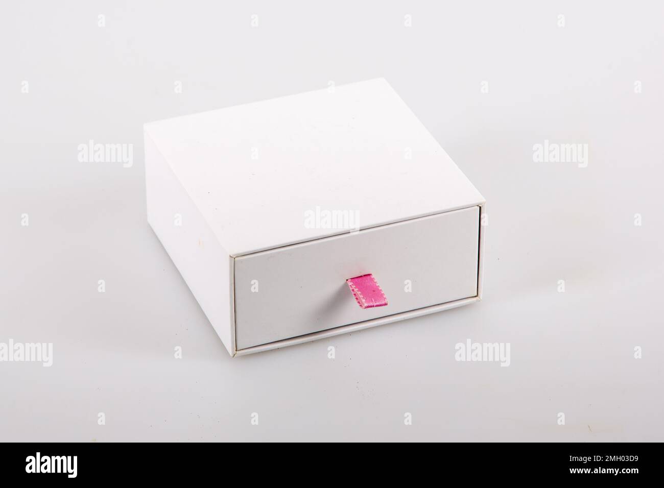 white small cardboard sliding box with drawer pink ribbon Stock Photo ...
