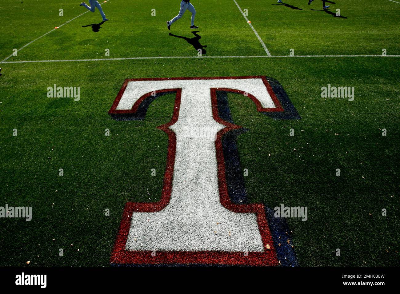 Texas Rangers players run sprints during spring training baseball ...