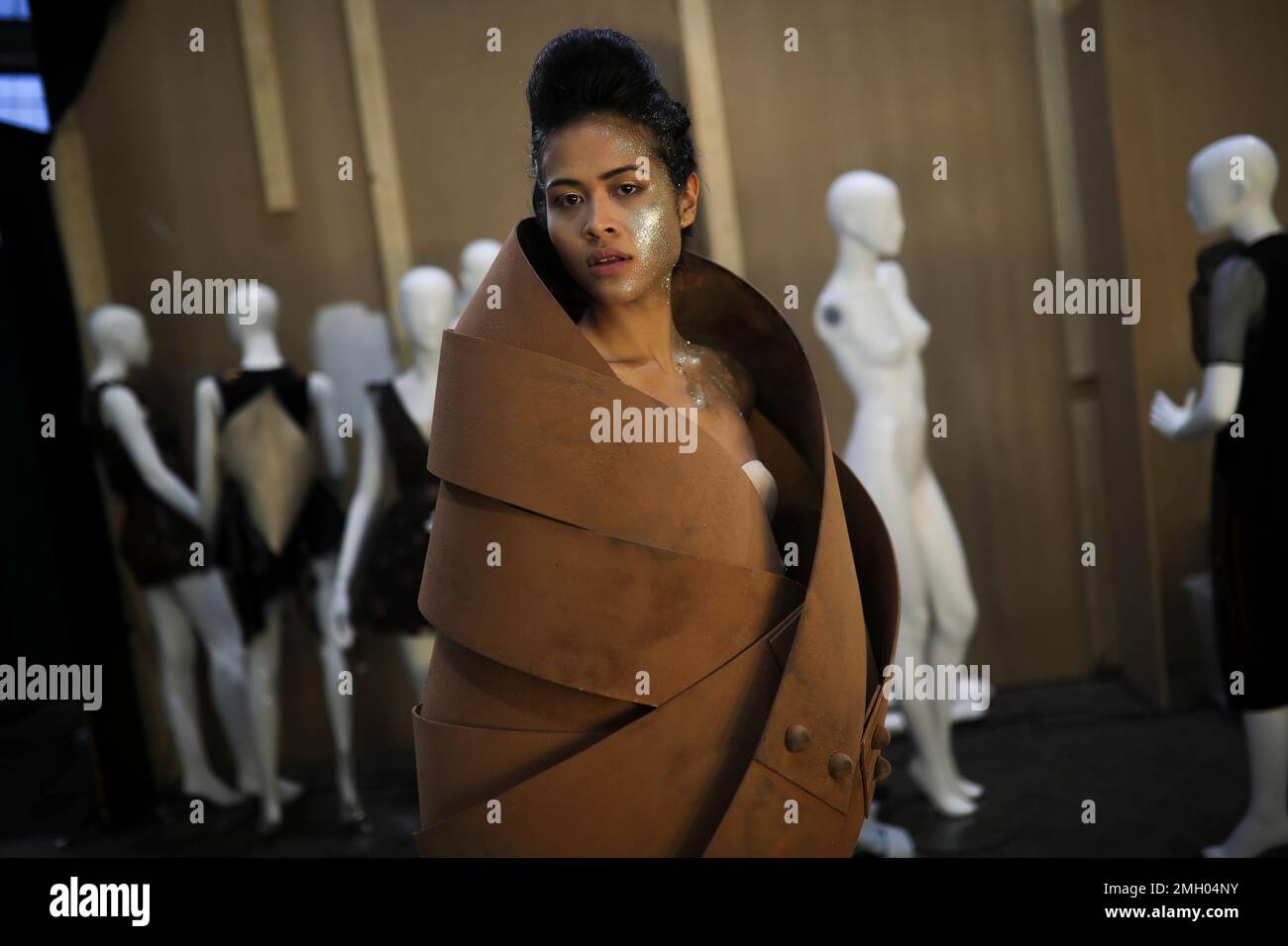 A model wearing a creation made of chocolate poses for a photograph ...