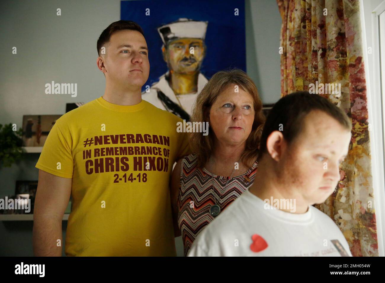 The Hixon family, Tom, Debbi, and Corey, pose for a portrait in front ...