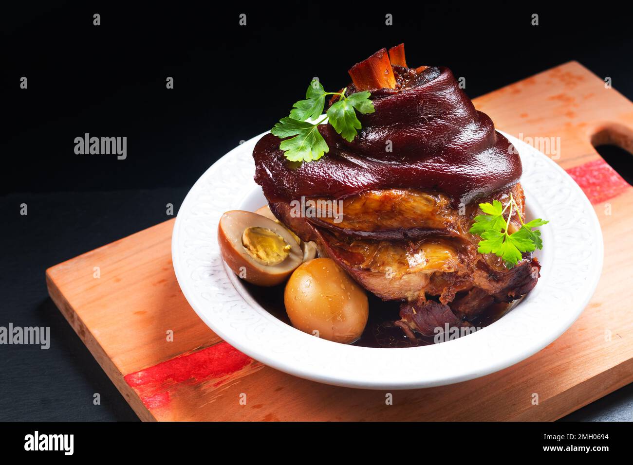 Asian food concept Chinese 5 Spice Braised Pork Knuckle on wooden board ...