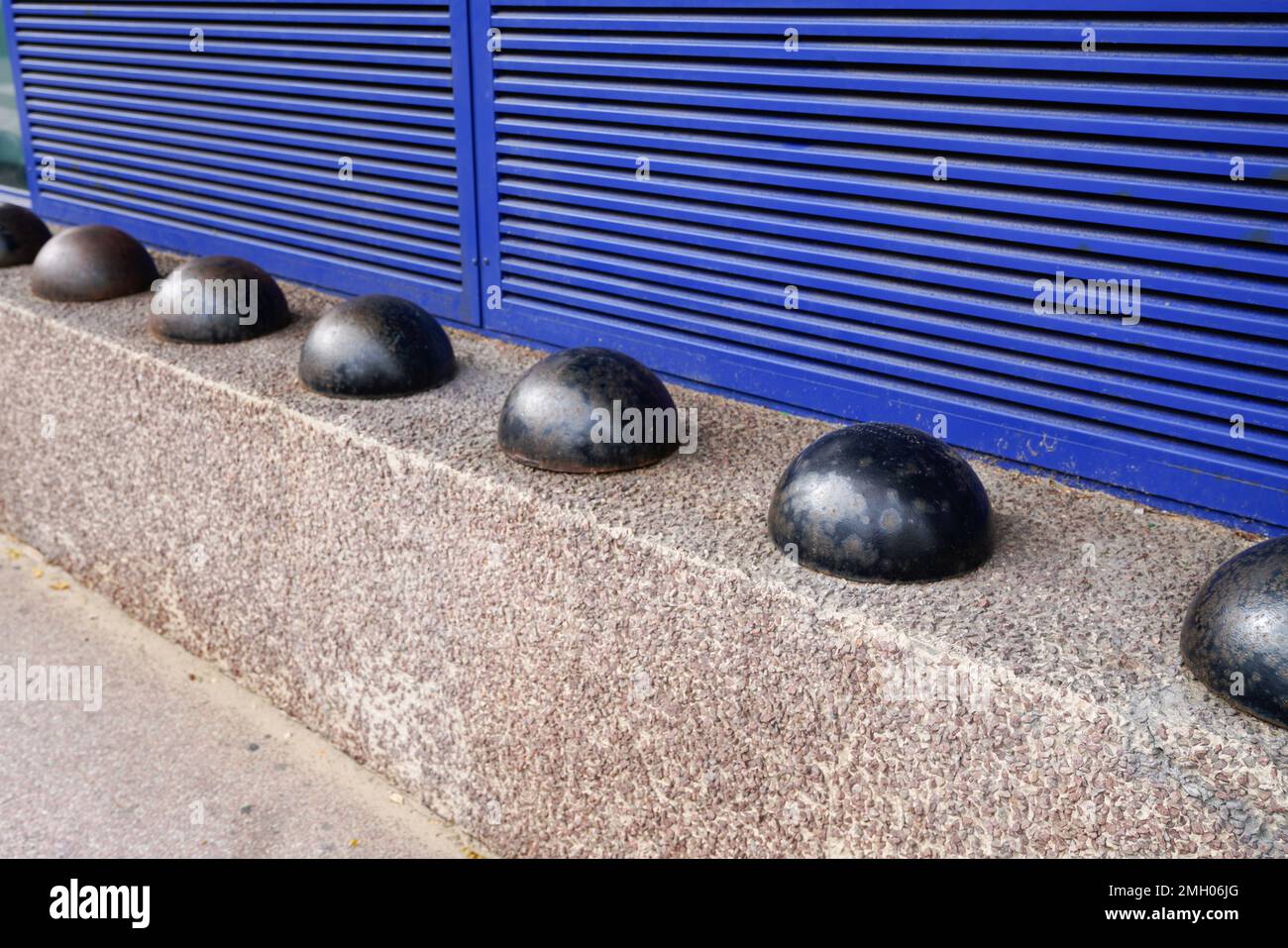 hostile design steel half ball mounted front of building on the edge of ...
