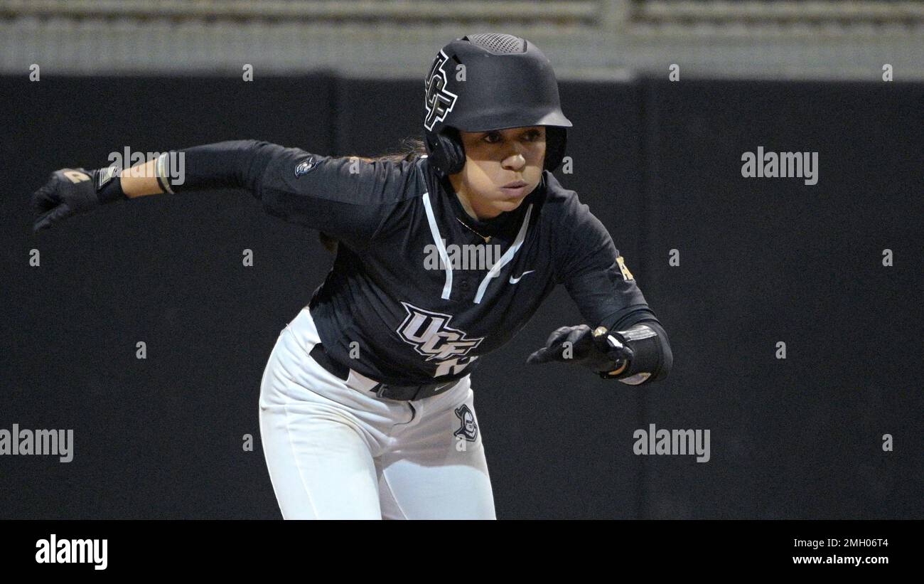 Central Florida's Justene Molina (12) runs to first base after bunting ...