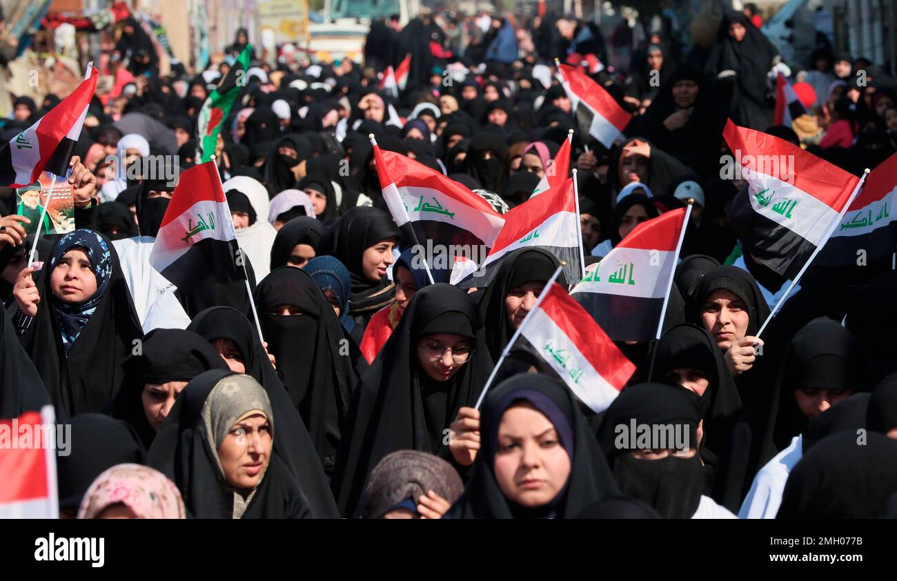 Followers of Iraq's Shiite cleric Muqtada al-Sadr chant slogans as they ...