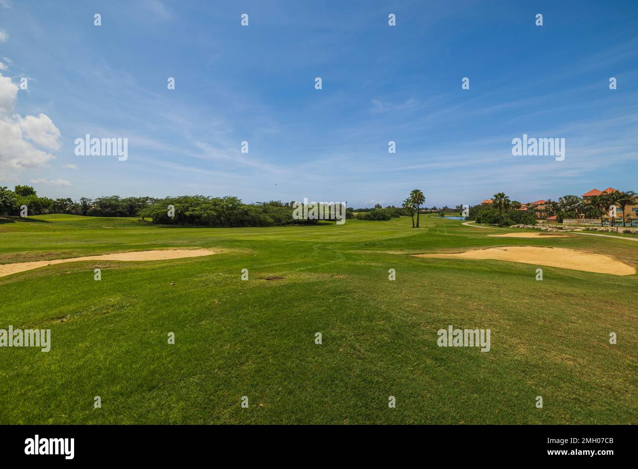 Gorgeous view of green grass golf field on background blue sky. Aruba ...