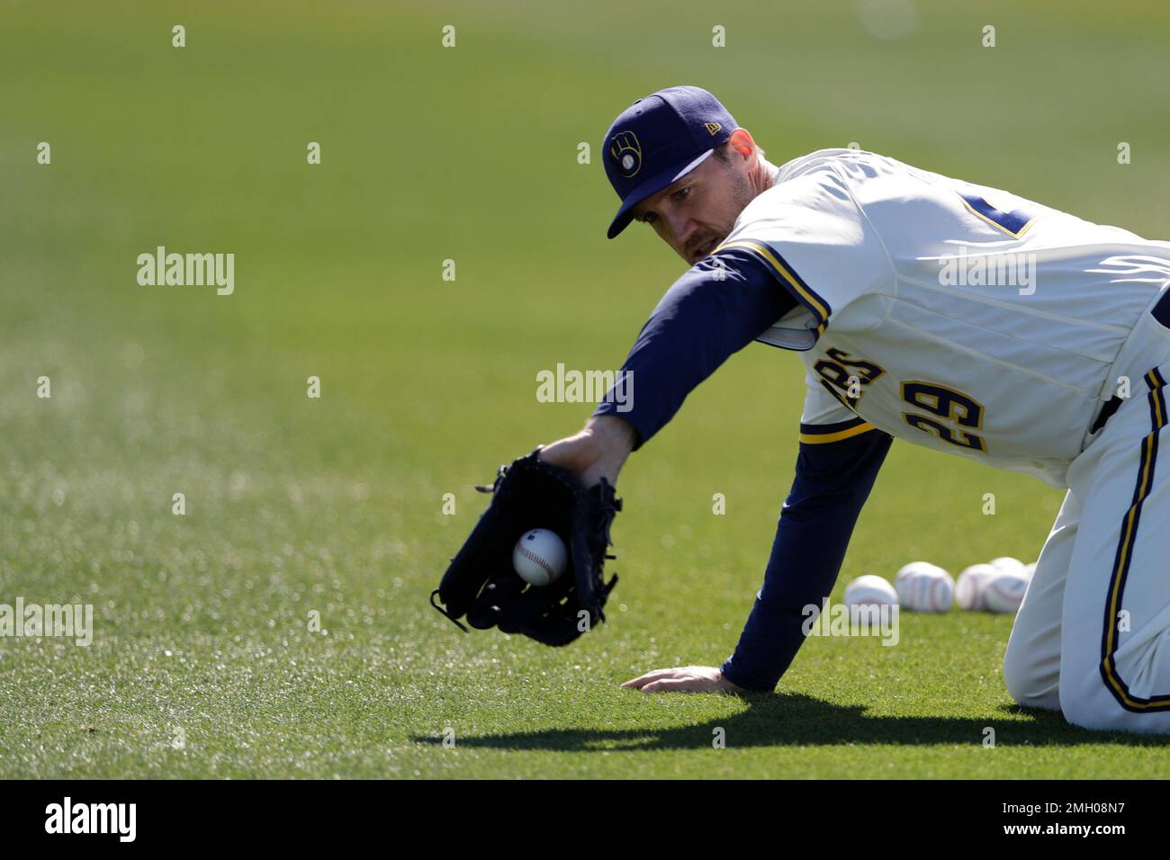 Milwaukee Brewers pitcher Josh Lindblom makes a catch during spring ...