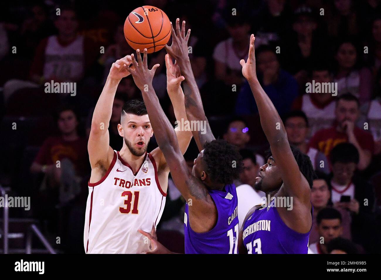 Southern California forward Nick Rakocevic, left, passes the ball while ...