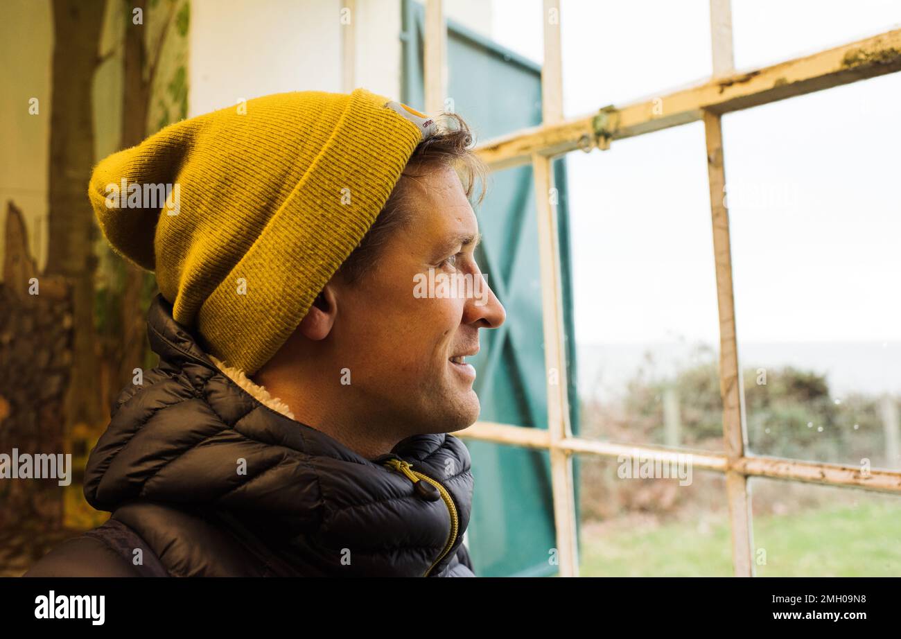 man looking out of a window at the rain Stock Photo - Alamy