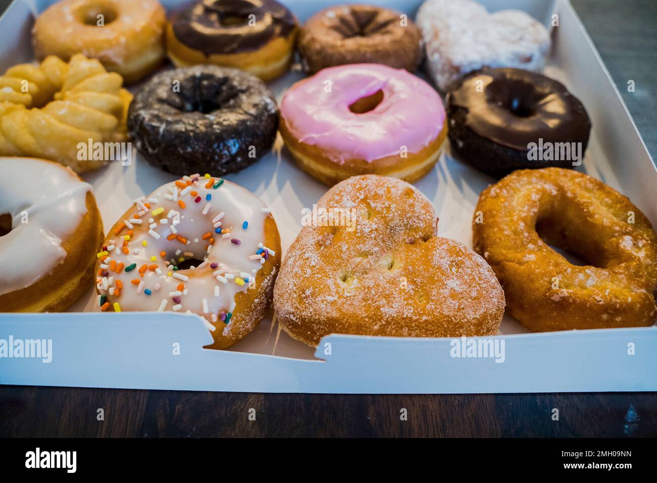 Close Up of Variety of Donuts in White Box on Table Stock Photo - Alamy