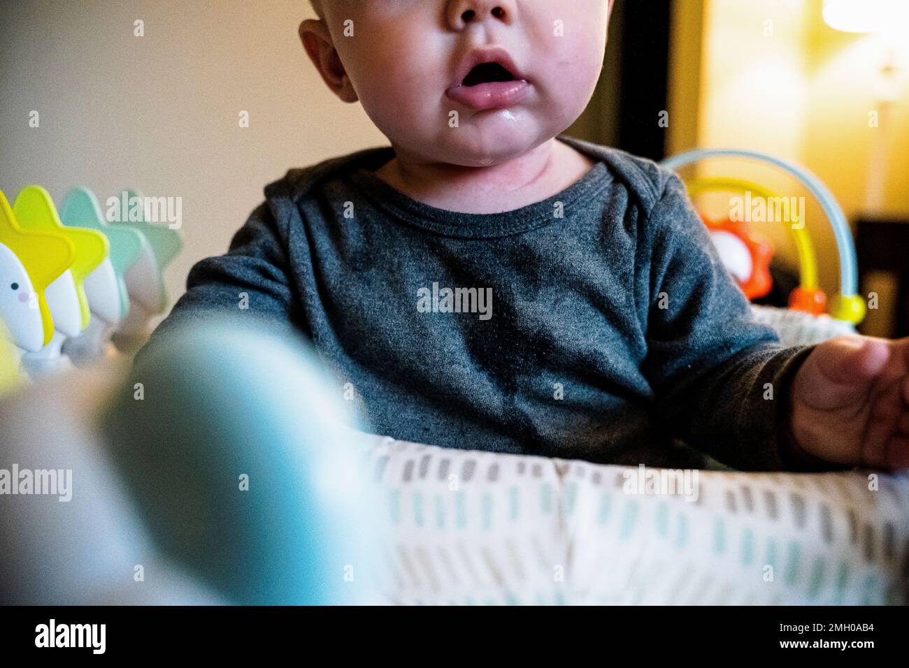 Baby Boy Drooling While Sitting in Activity Center Stock Photo - Alamy
