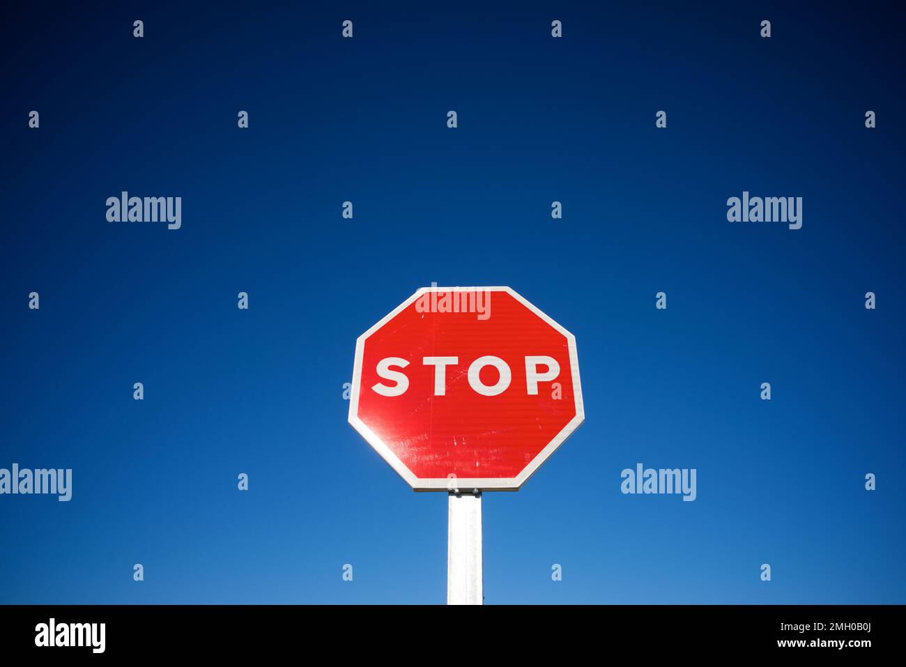 Stop traffic sign with cloudless sky Stock Photo - Alamy