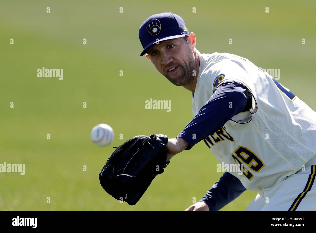 Milwaukee Brewers pitcher Josh Lindblom makes a catch during spring ...