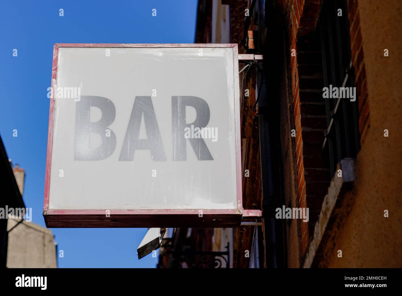 bar sign text on wall pub in city street storefront building entrance ...