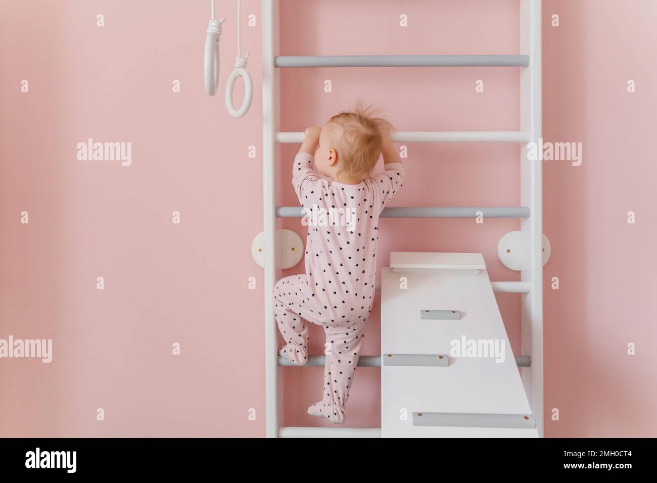 Child hanging on gymnastic rings hi-res stock photography and images ...