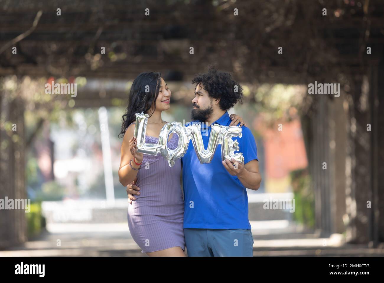 Young latino couple holding hi-res stock photography and images - Alamy