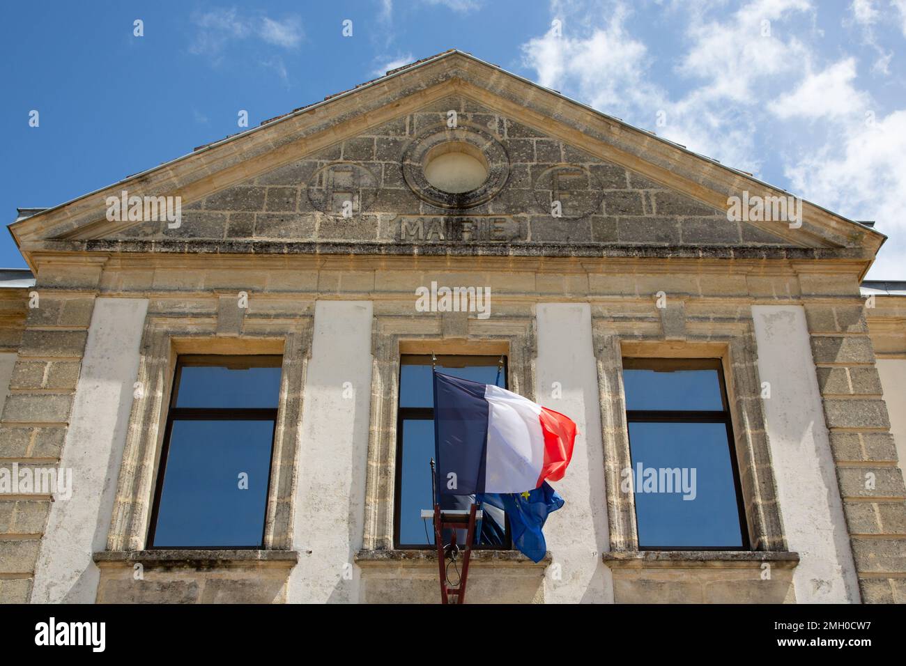 city hall and france flag in town center with french flag on stone ...
