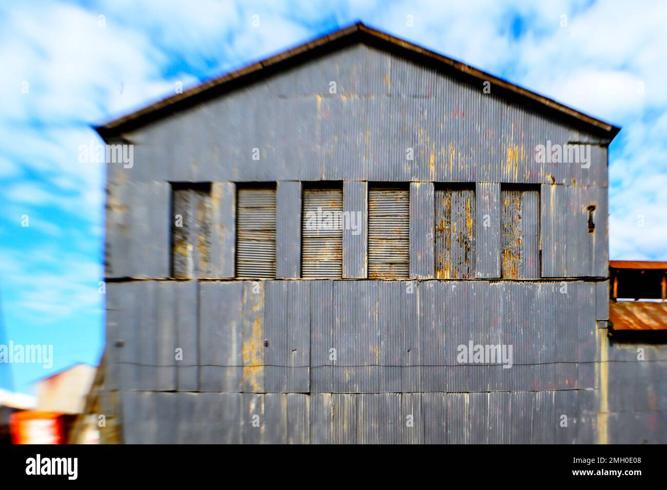 Exterior of an old storage building with metal siding Stock Photo - Alamy