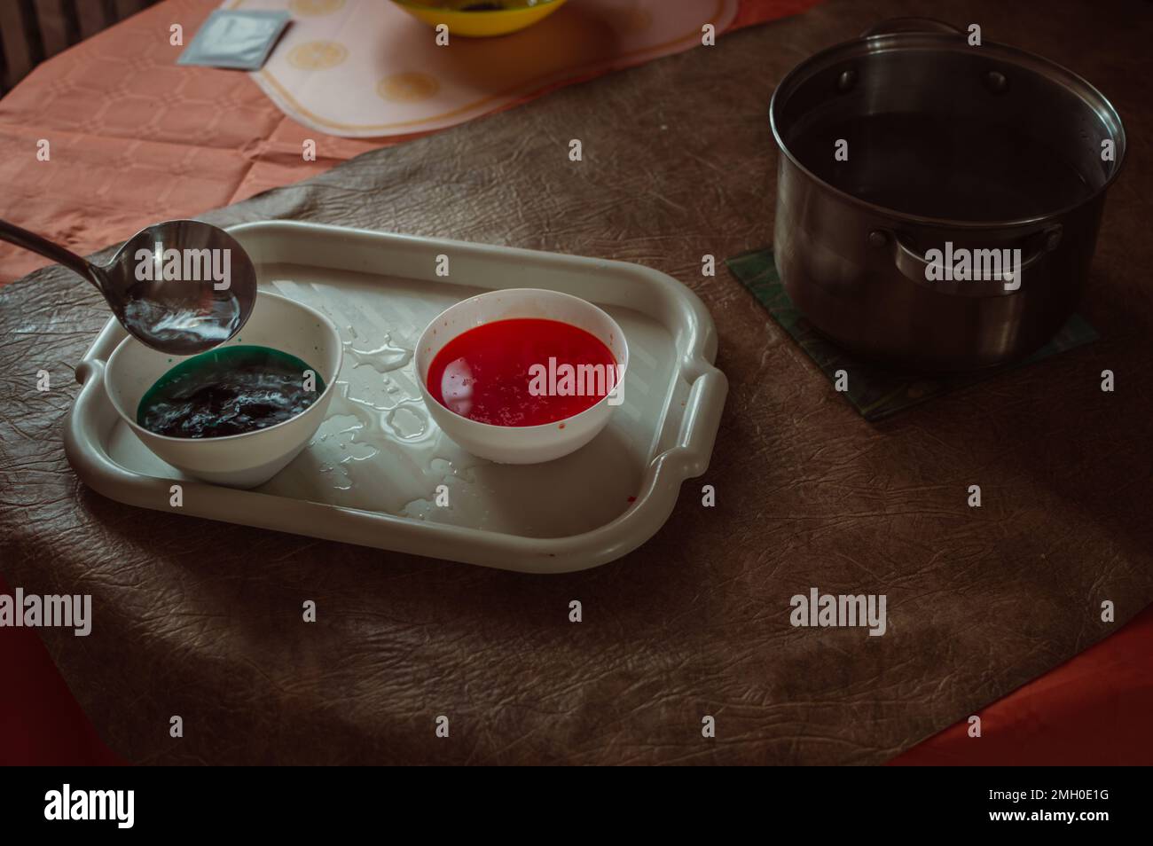 Pouring liquid paints for coloring Easter eggs Stock Photo - Alamy