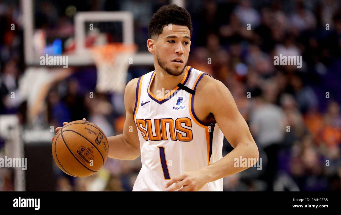 Phoenix Suns guard Devin Booker (1) looks to pass against the Golden ...
