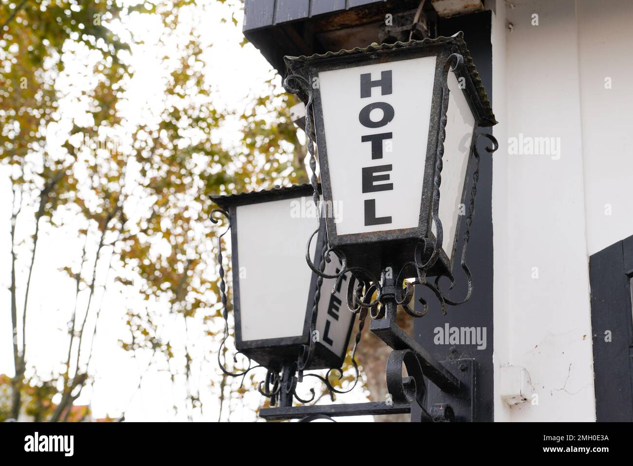 Hotel sign text write on old lamp vintage retro front of building in ...