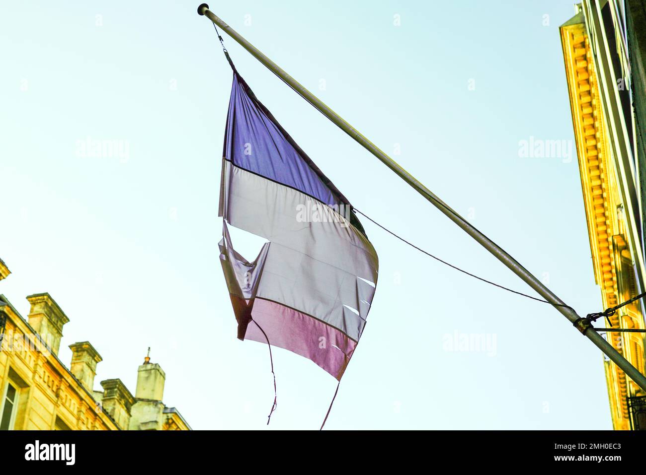 French flag worn faded torn blue white red of france on building Stock ...