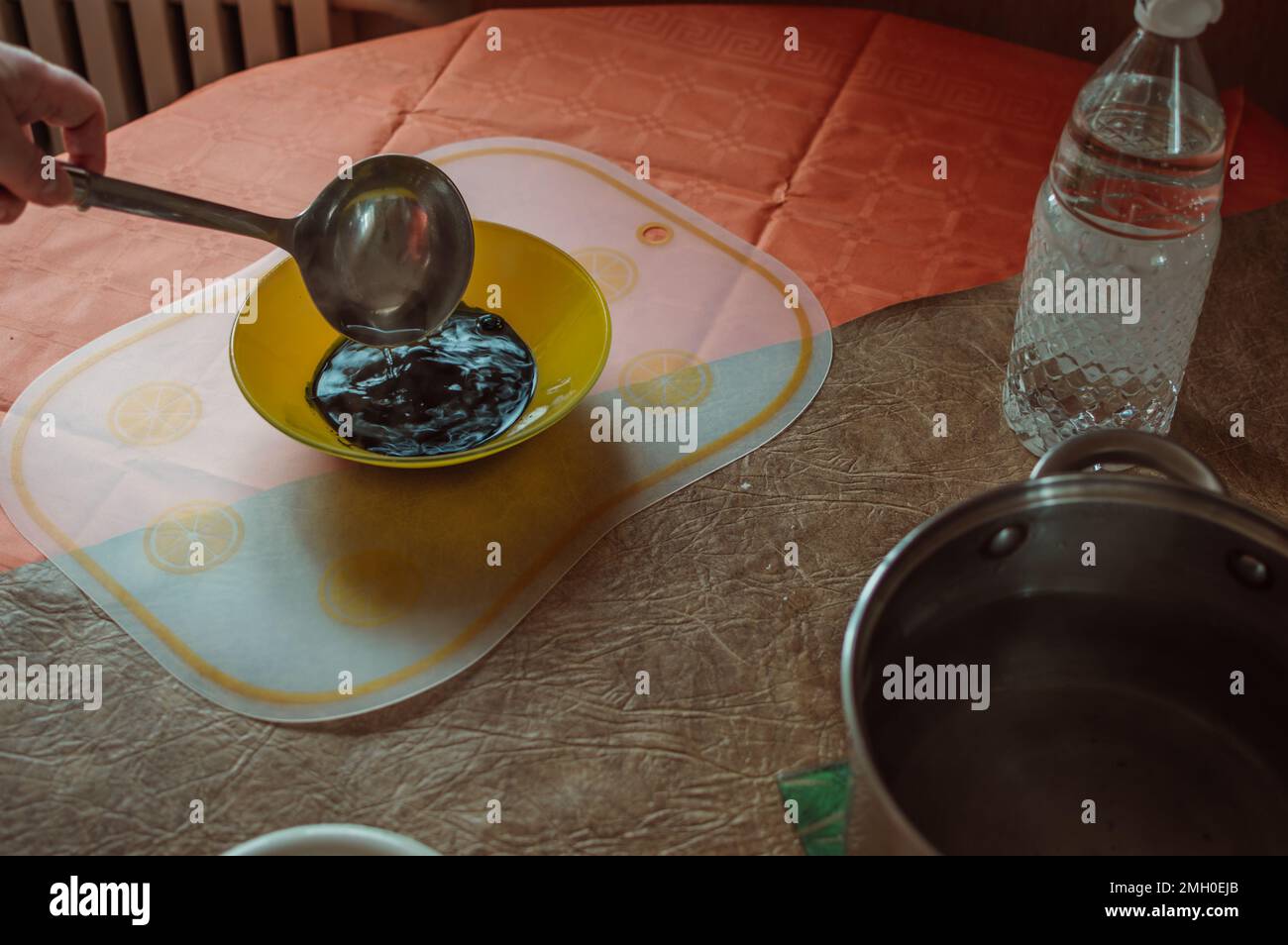 Pouring liquid paints for coloring Easter eggs Stock Photo - Alamy