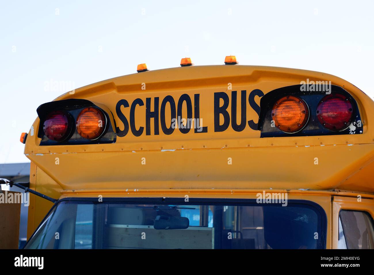 yellow school bus Front view with text sign and security light Stock ...