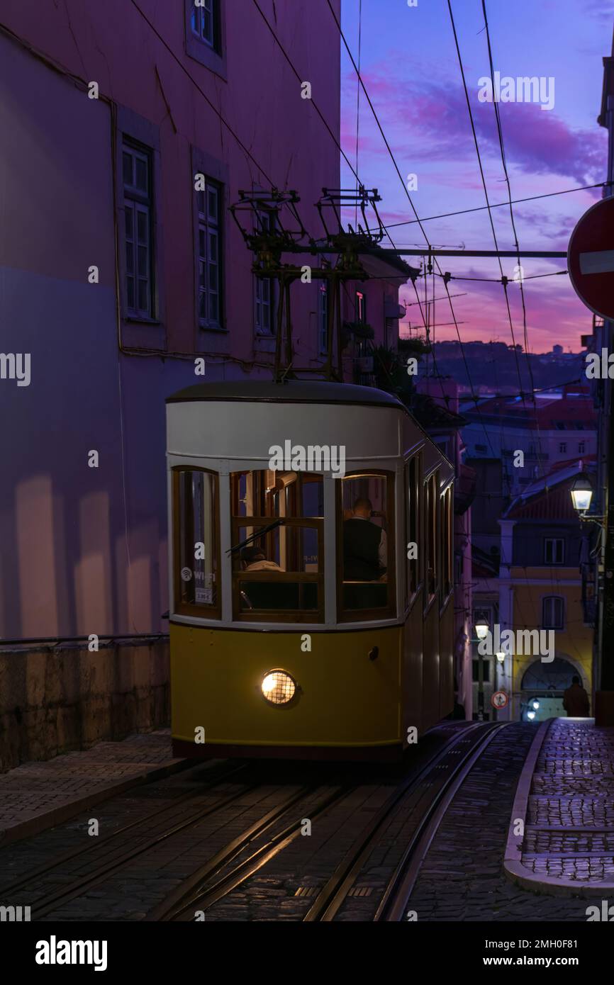 Antique yellow cable car on a narrow Portuguese street at sunset Stock ...