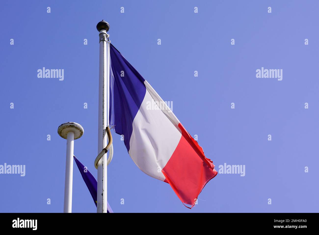 French flag of France wave over a blue cloud sky red blue white colors ...