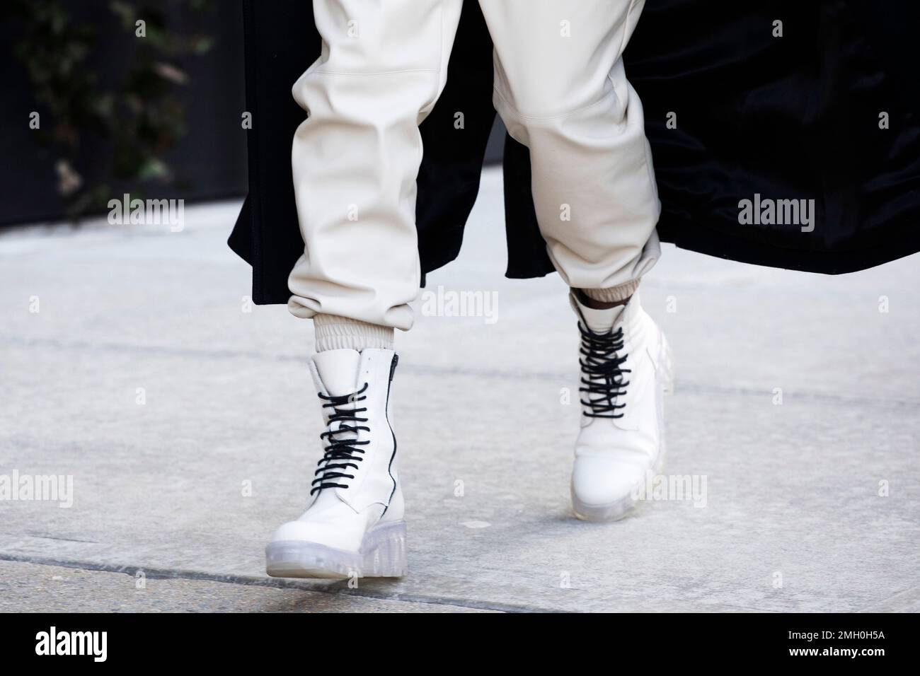 A model walks in laced white boots while arriving for a show during ...