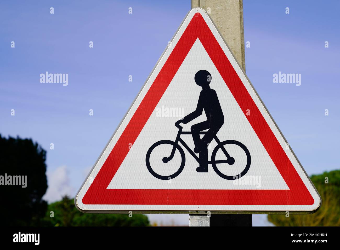 Car overtakes cyclist bicycle warning sign road danger Stock Photo - Alamy