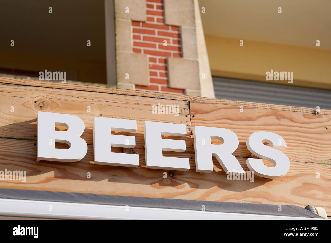 beers bar sign text on pub in city street storefront facade building ...