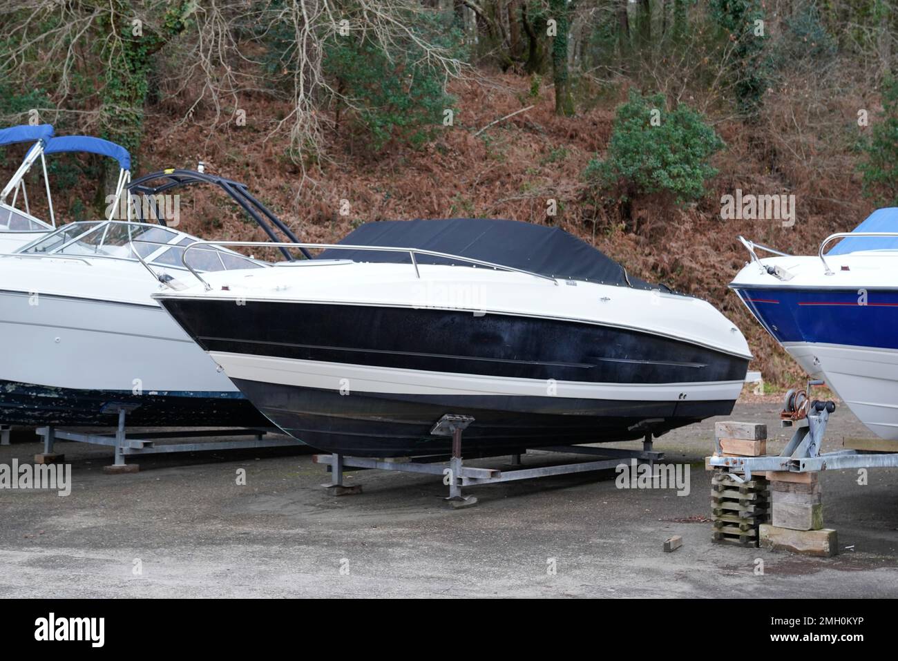 modern boat yachts stored up in dry storage waiting for maintenance ...