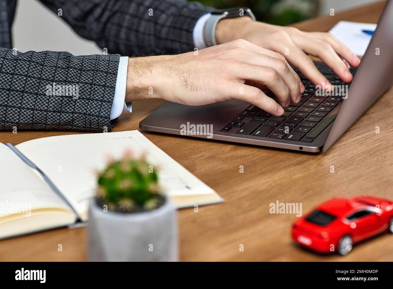 Male hands typing on a laptop keyboard Stock Photo - Alamy