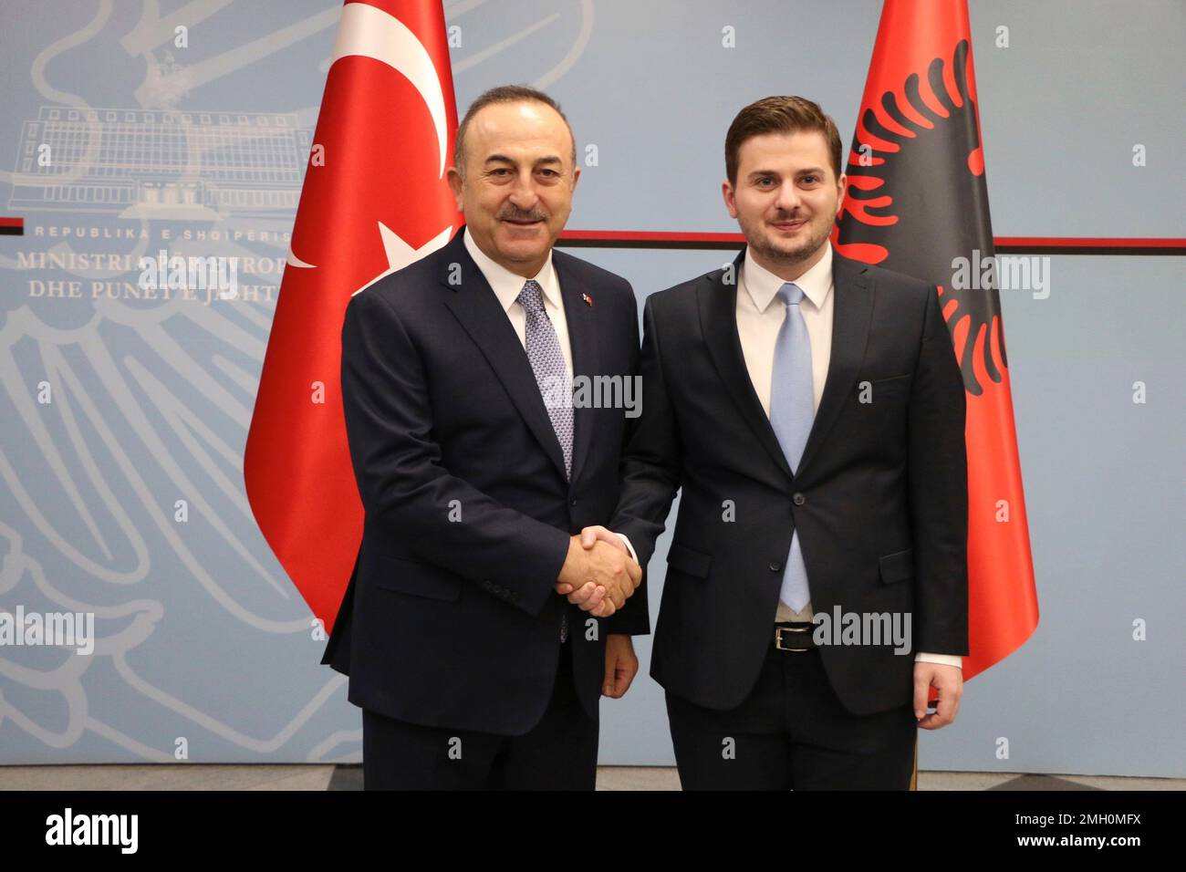 Albanian Foreign Minister Gent Cakaj, right, shakes hands with his ...