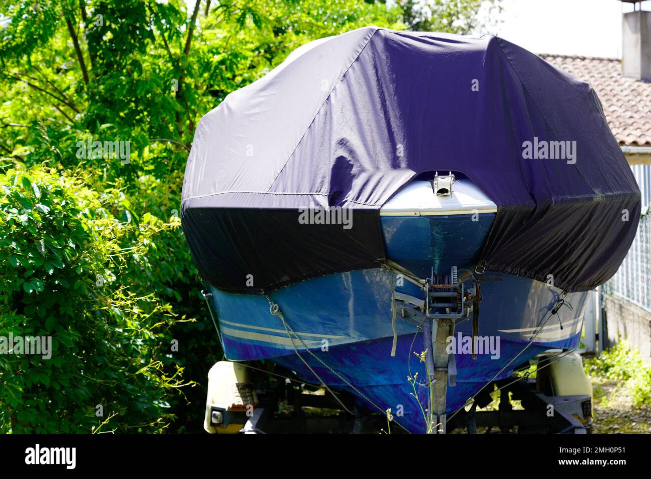 boat protected by blue tarp protective cover tarpaulin jacket on car ...