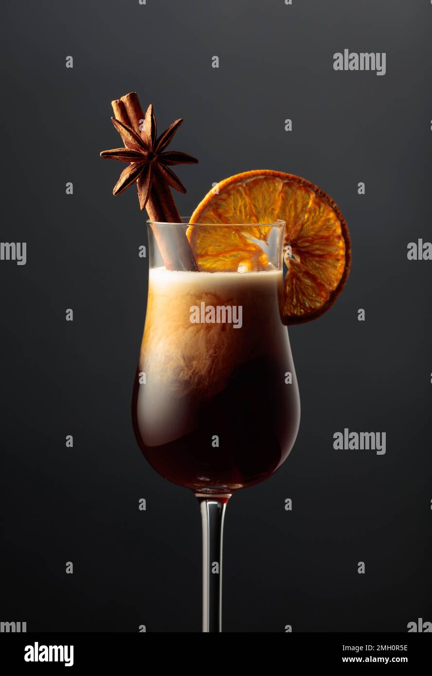 White Russian cocktail garnished with cinnamon, anise, and dried orange ...