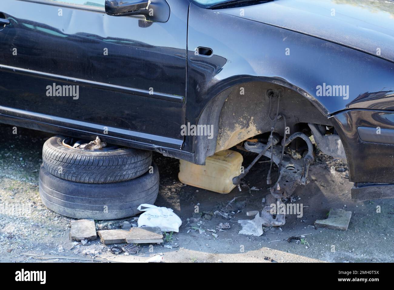 black passenger car repaired without a front wheel or with stolen ...