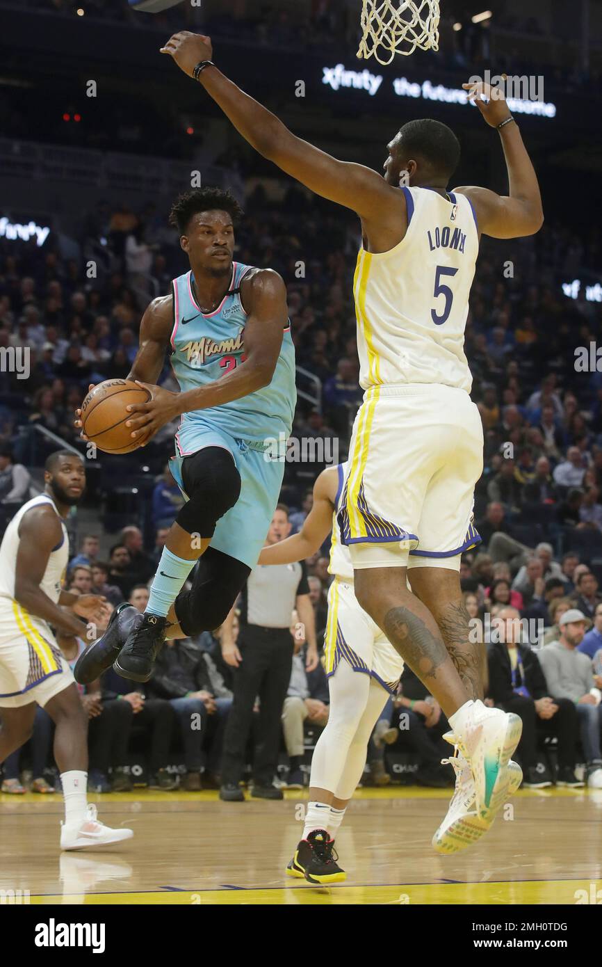 Miami Heat forward Jimmy Butler (22) is defended by Golden State ...