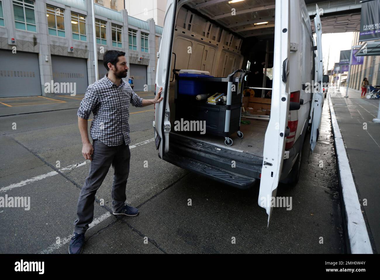 In this Jan. 14, 2020 photo, Chris Hill closes a van door carrying a ...