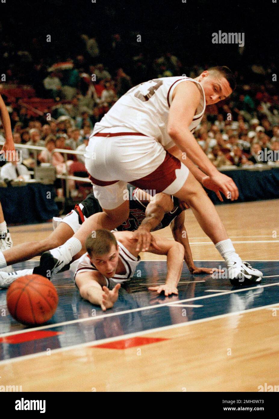 Colgate's Tucker Neale, on floor, reaches for the ball as teammate Tim ...