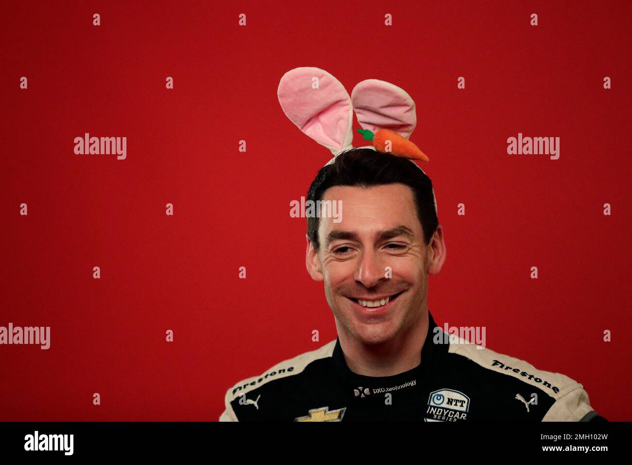 IndyCar driver Simon Pagenaud wears bunny ears as he poses for a photo ...