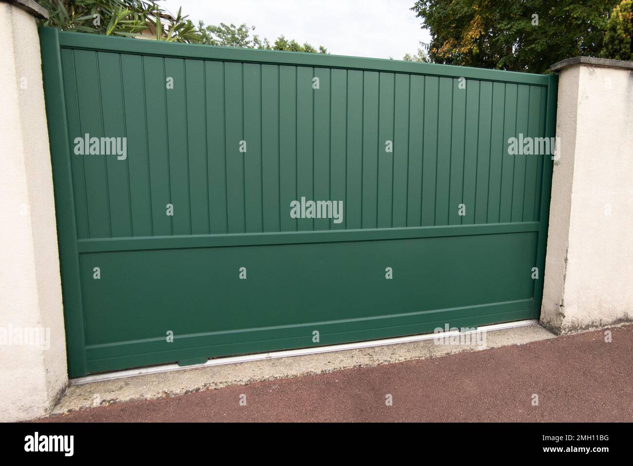 steel sliding high green metal gate on modern house street Stock Photo ...
