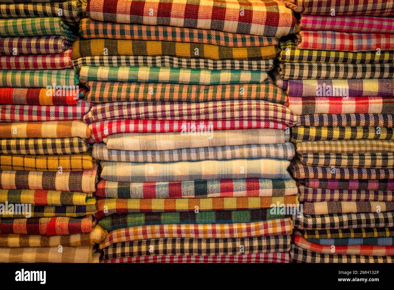 Colourful colorful fabrics sold at a street stall at a market in Hanoi ...